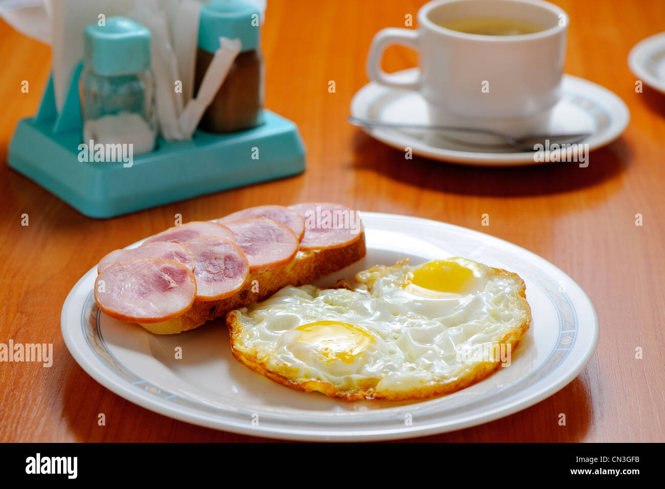 Breakfast. Fried eggs, a sandwich and tea Stock Photo - Alamy