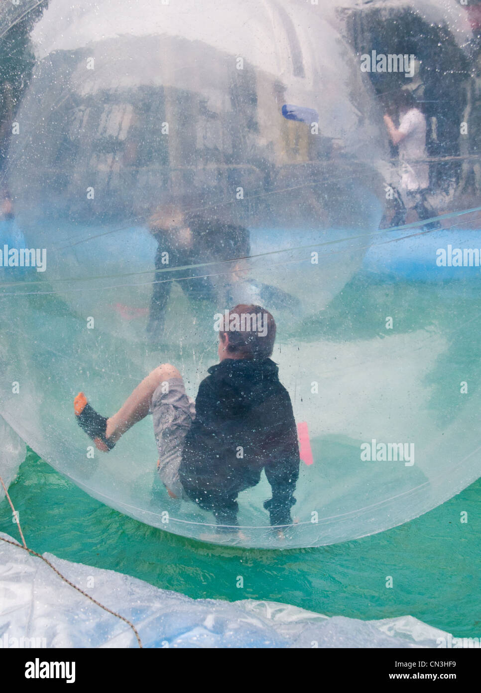 Boys playing in an inflatable 'water walker' ('hamster ball ...