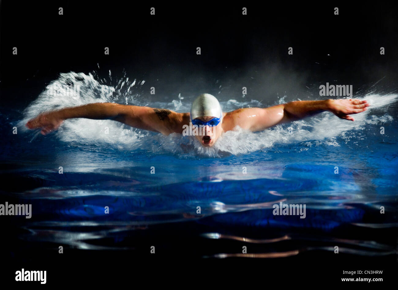Young man swimming in pool Stock Photo - Alamy