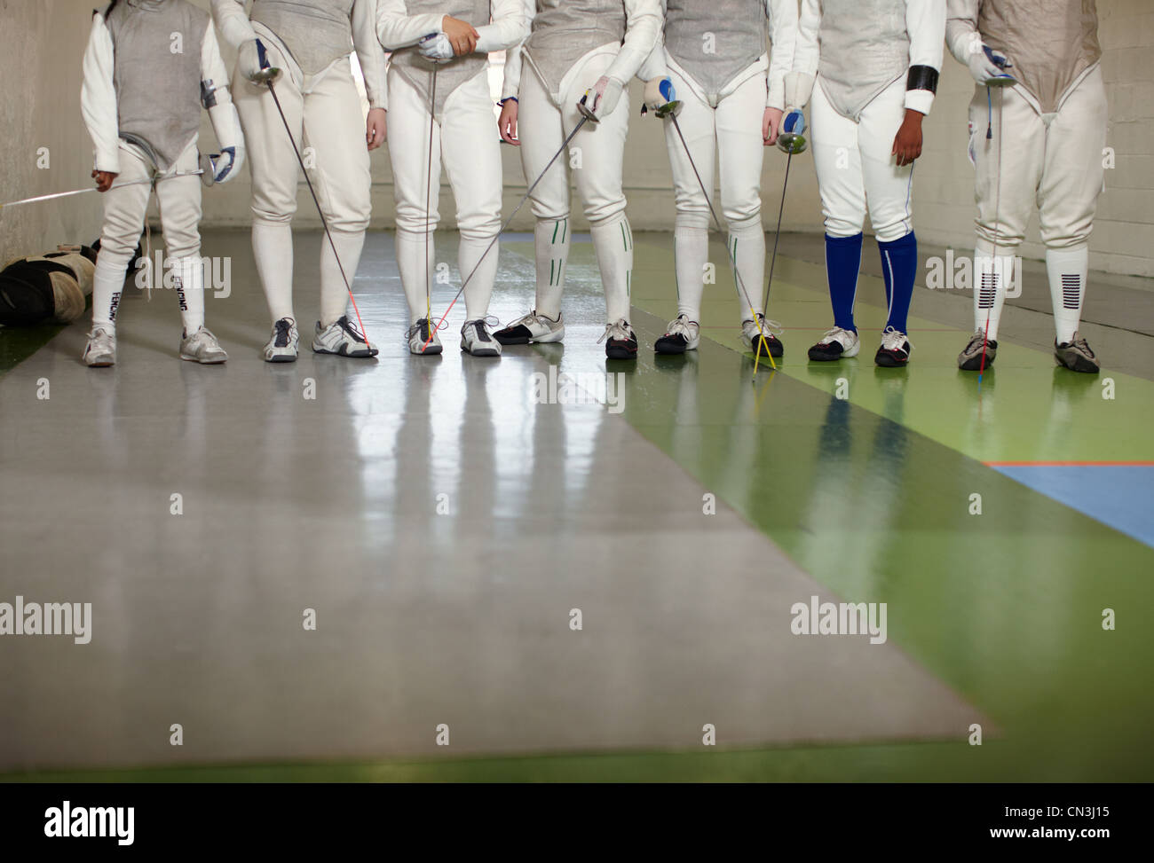 Female fencers standing together in a row, low section Stock Photo - Alamy