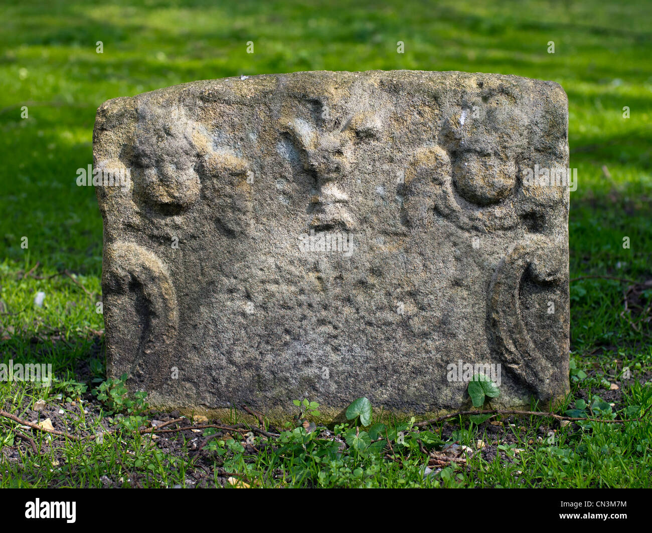 An old weathered gravestone on which the original inscription has long ...
