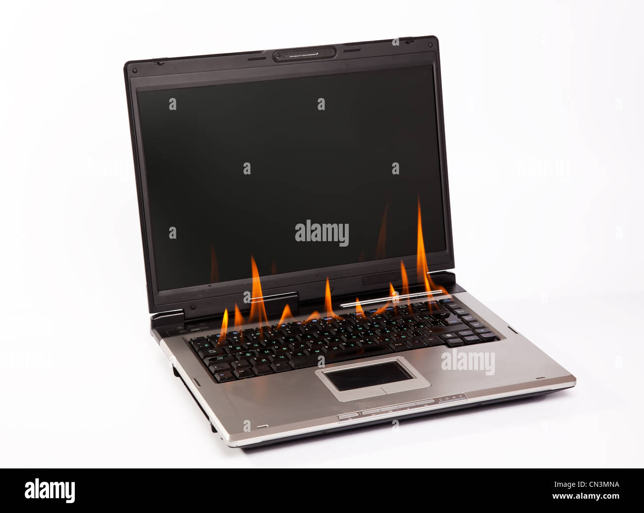 Laptop burning with fire on white background Stock Photo - Alamy