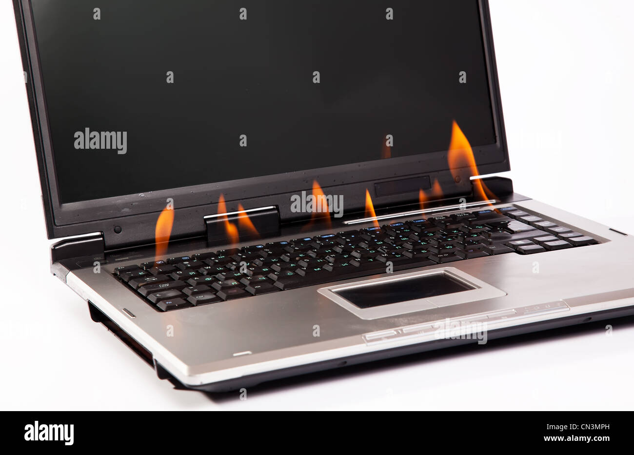 Laptop burning with fire on white background Stock Photo - Alamy