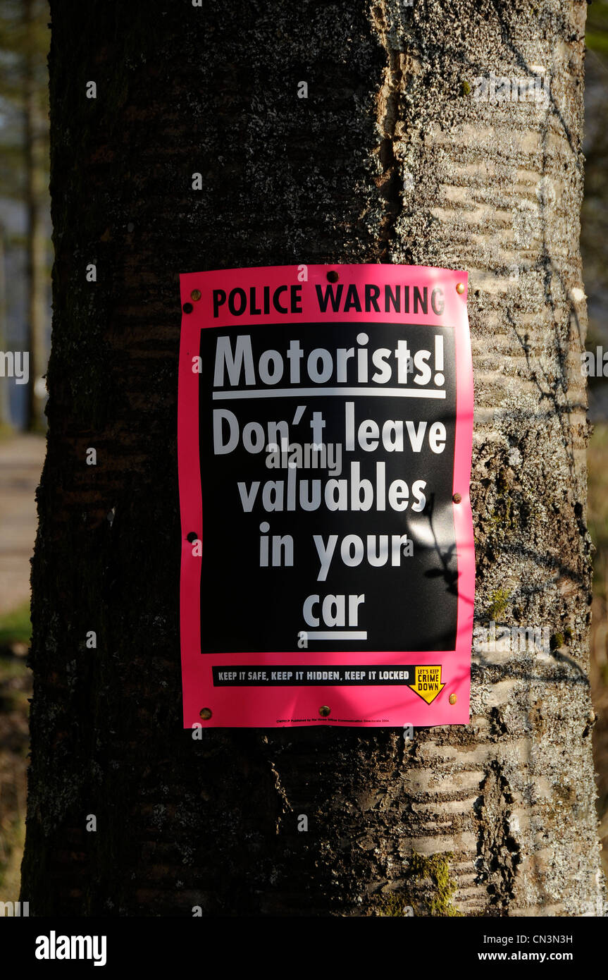 Police warning sign on a tree Stock Photo - Alamy