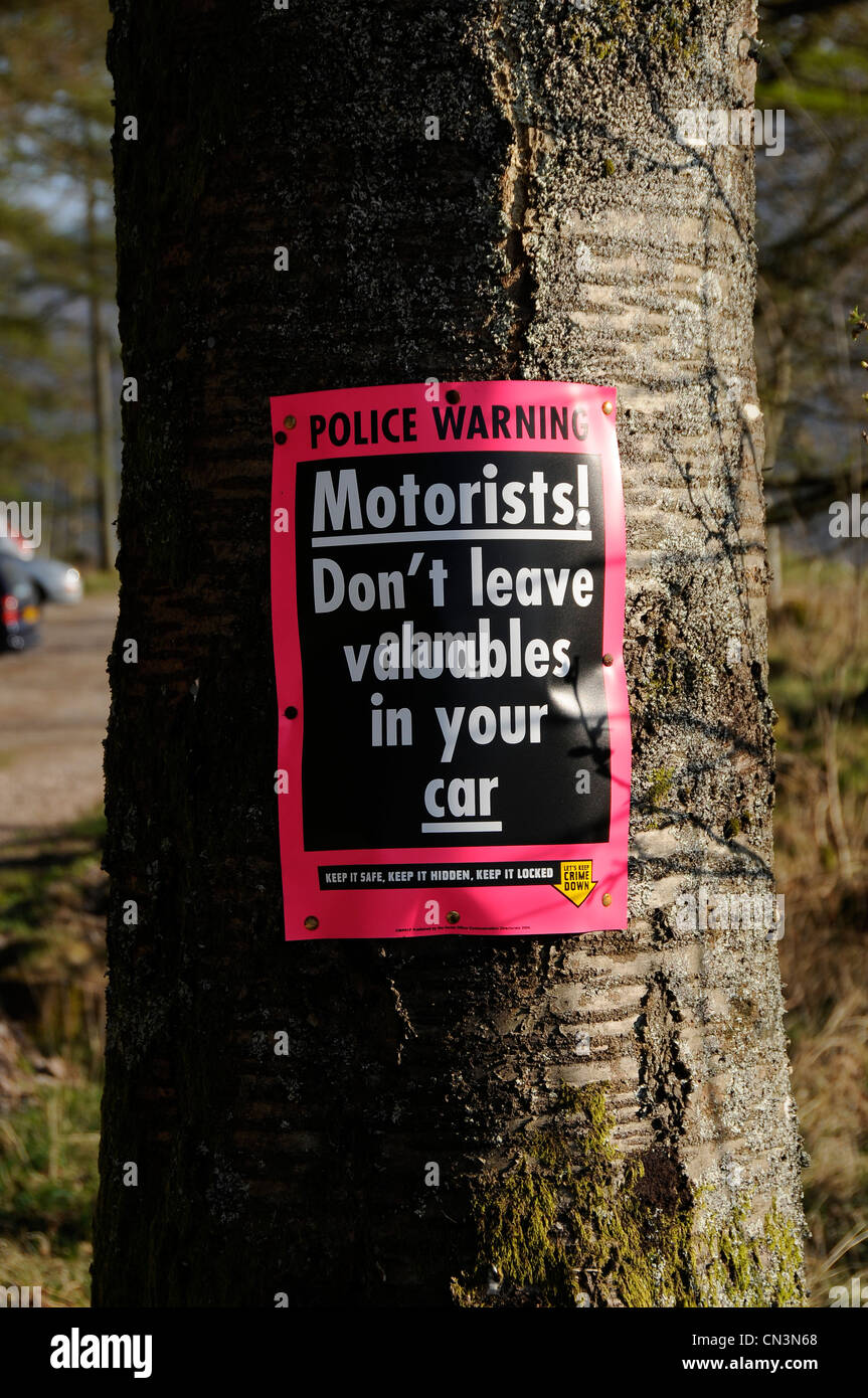 Police warning sign on a tree Stock Photo - Alamy