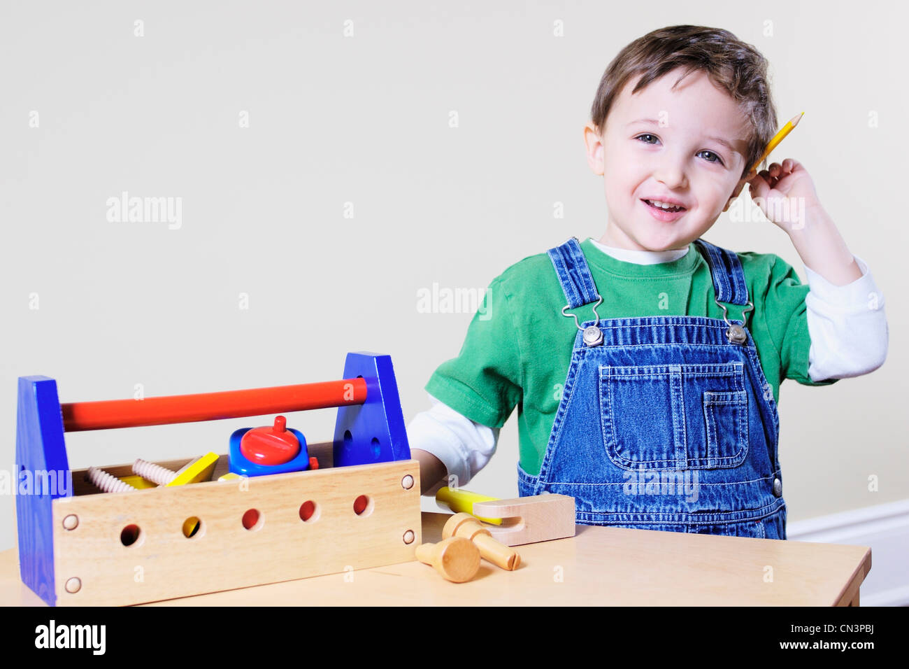 Boy Playing Carpenter with Toy Tools Stock Photo - Alamy