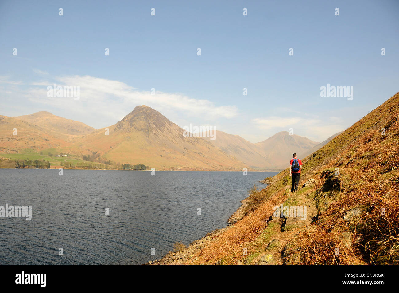 Young man walking on the screes at wastwater in the lake district uk ...