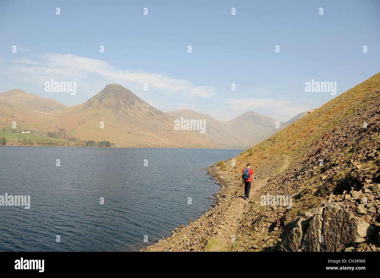 Young man walking on the screes at wastwater in the lake district uk ...