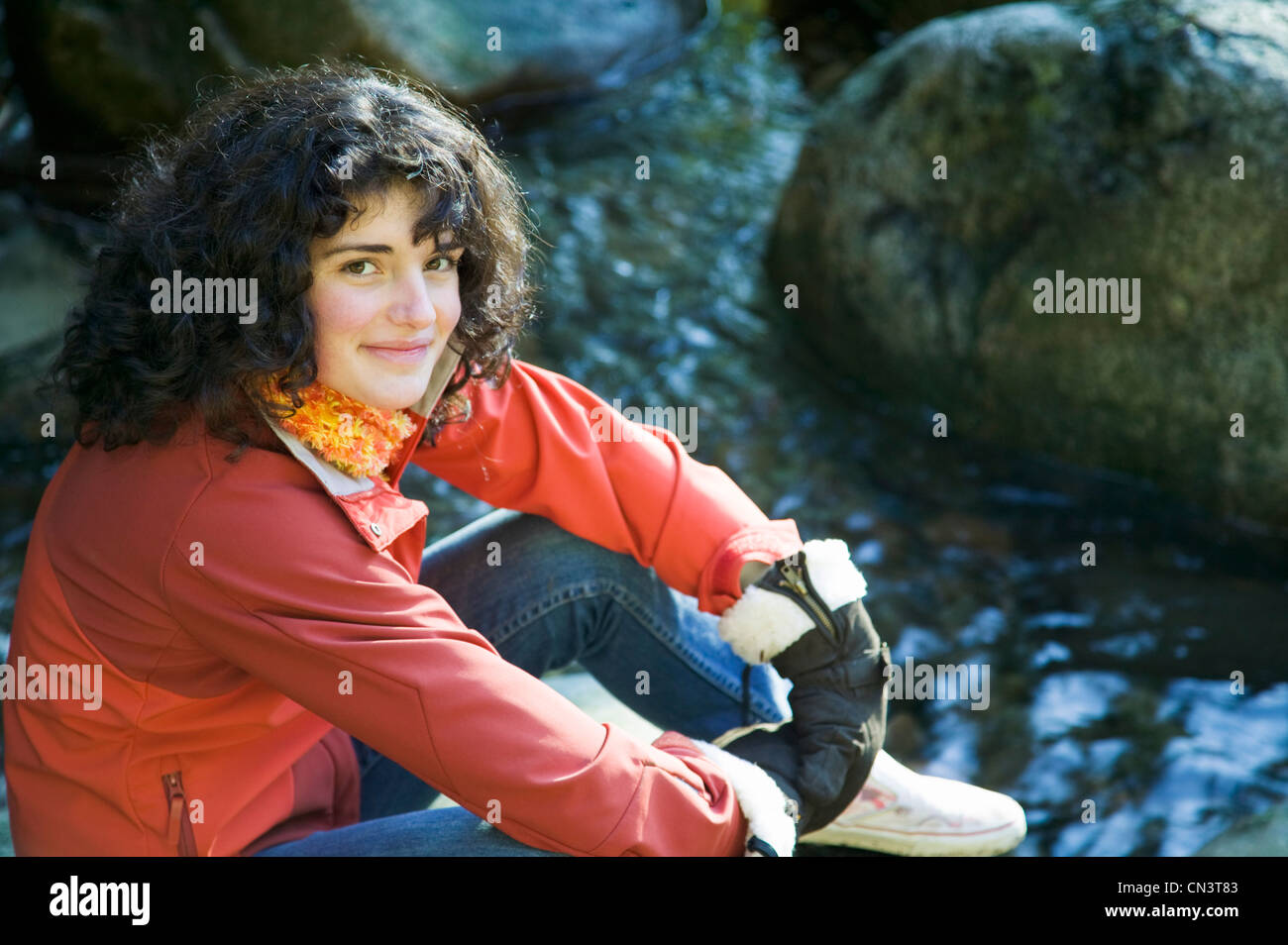 Teenage Girl Sitting by Stream Stock Photo - Alamy