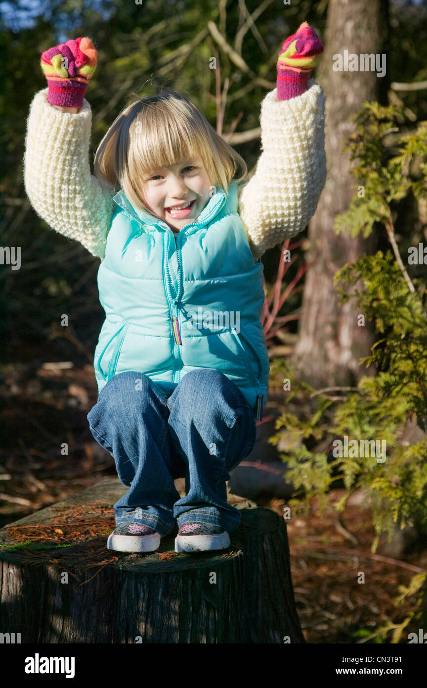 Girl Standing on Tree Stump Stock Photo - Alamy