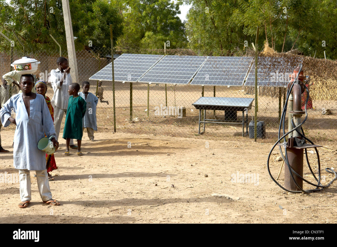 People standing infront of solar panels in africa Stock Photo - Alamy