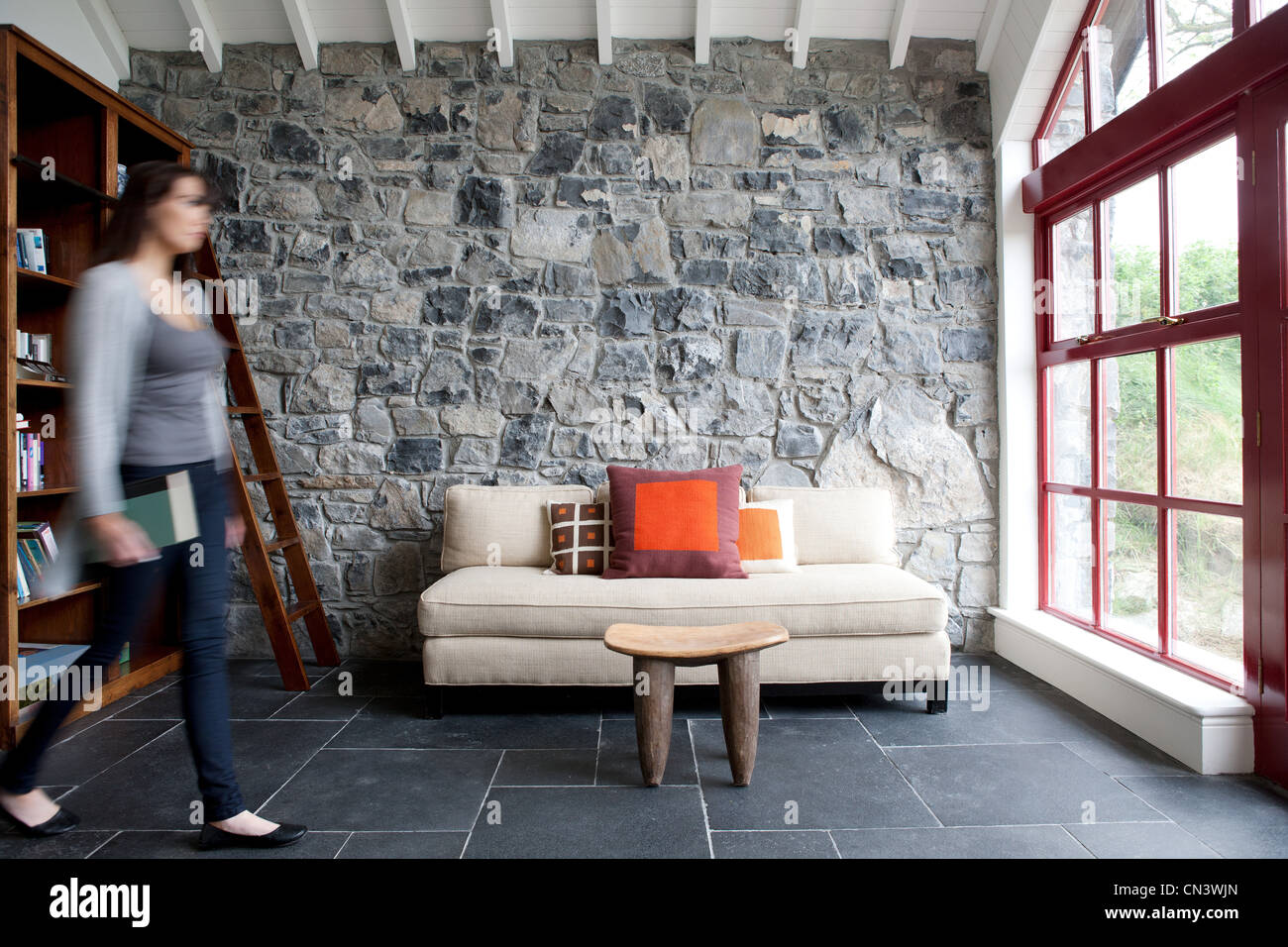 Woman entering living room Stock Photo - Alamy