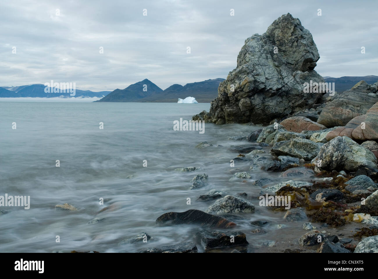 Summer iceberg along shoreline near Pond Inlet, Baffin Island, Nunavut ...