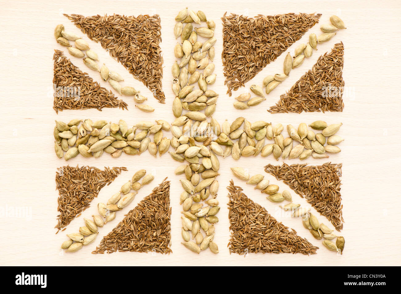 Union Flag created out of curry spices: whole cumin seeds and cardamom ...