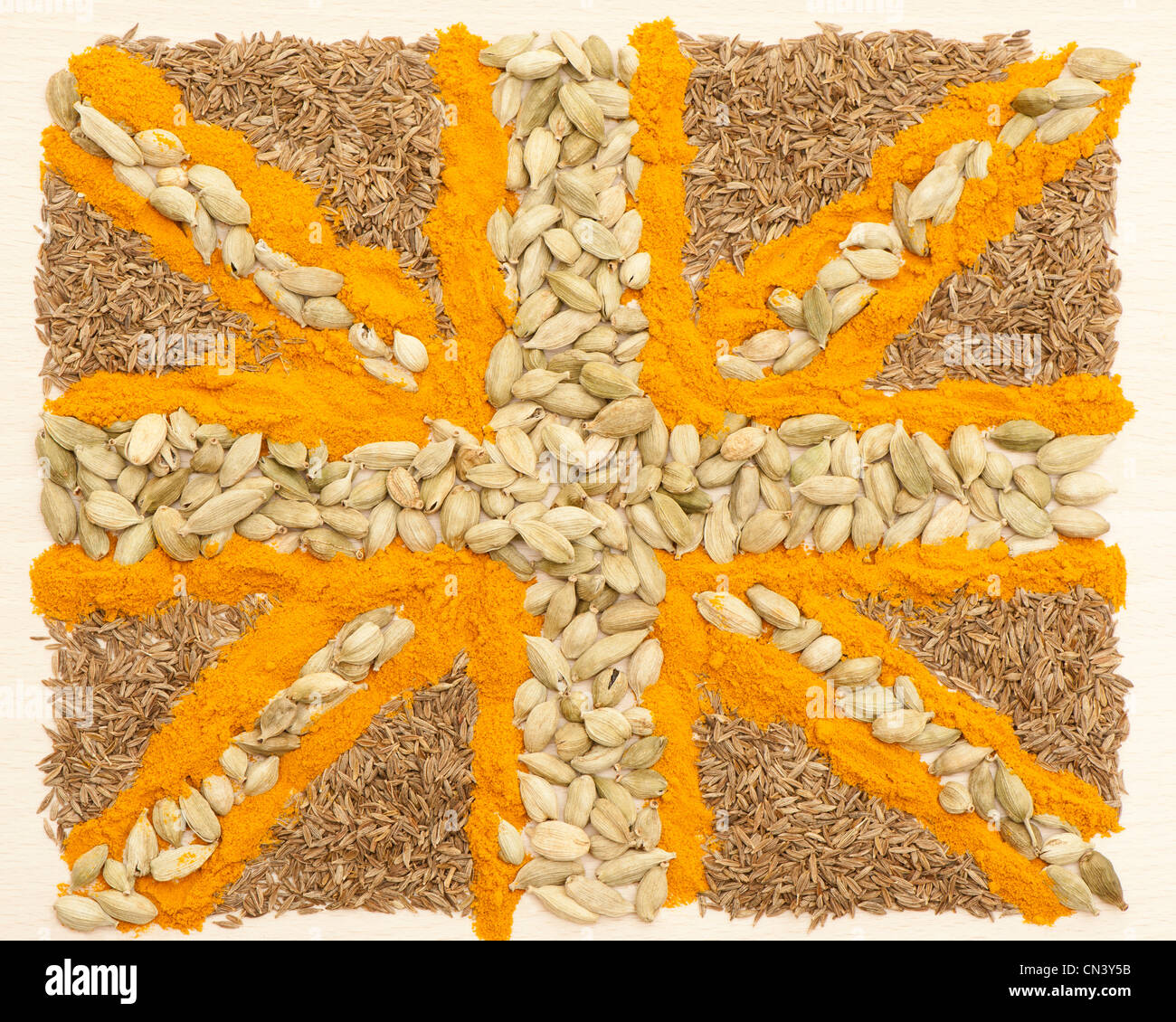 Union Flag created out of curry spices: whole cumin seeds, cardamom ...