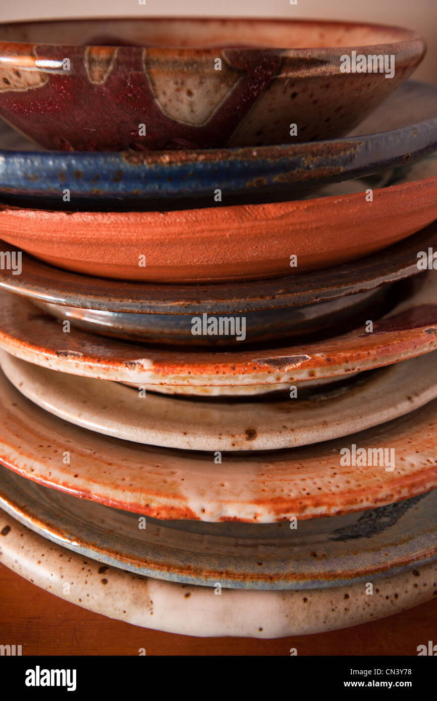 Distressed handmade and hand thrown earthenware dishes are seen in a ...