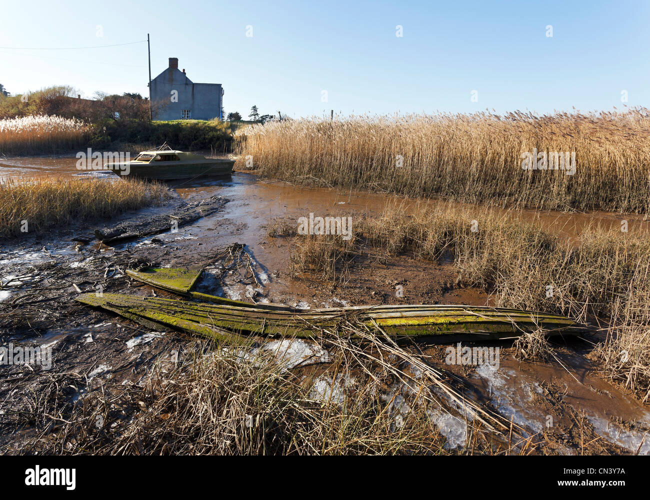 A rotten and dilapidated boat lies at rest on a "North Norfolk" "salt ...