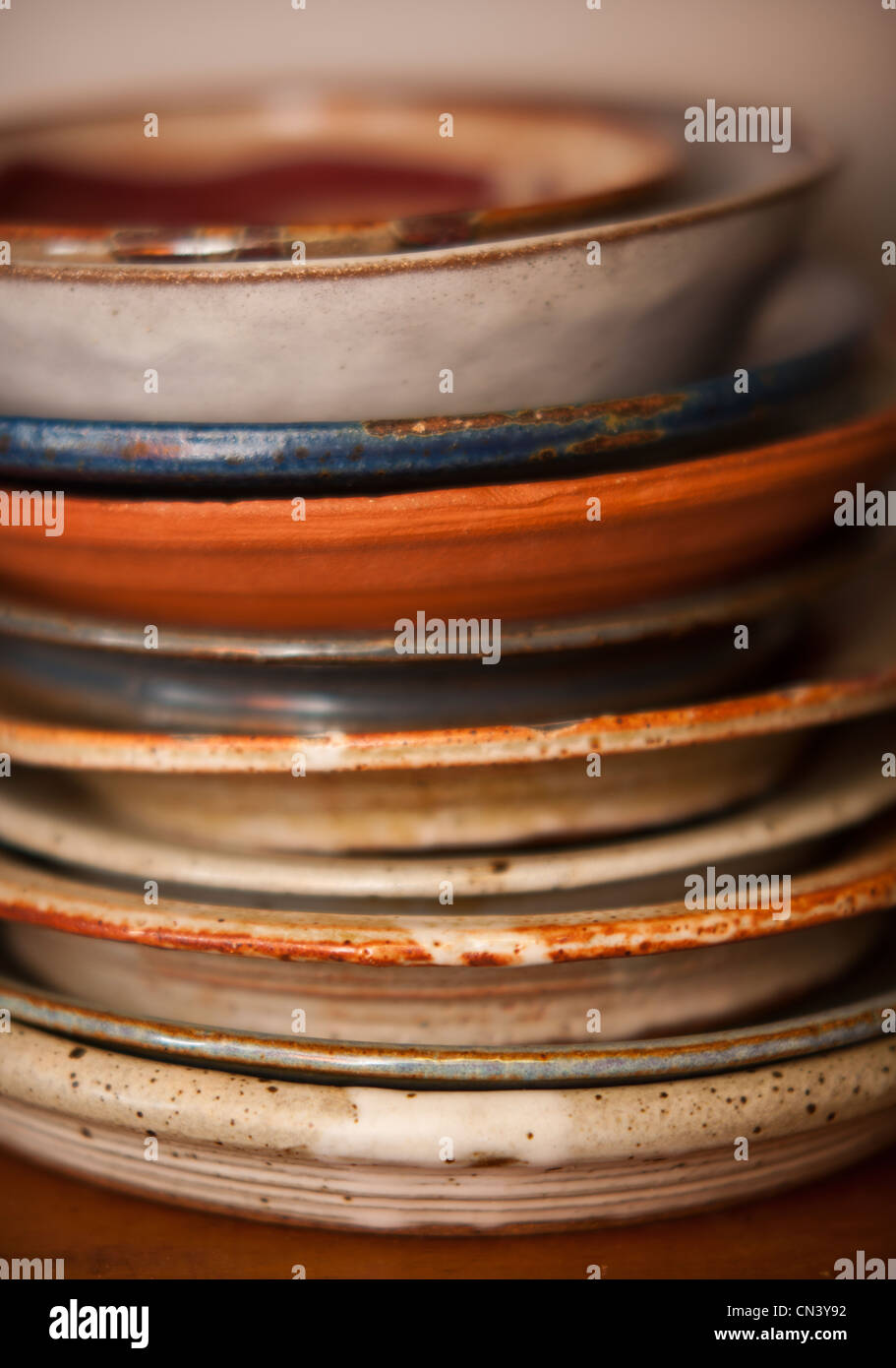 Distressed handmade and hand thrown earthenware dishes are seen in a ...