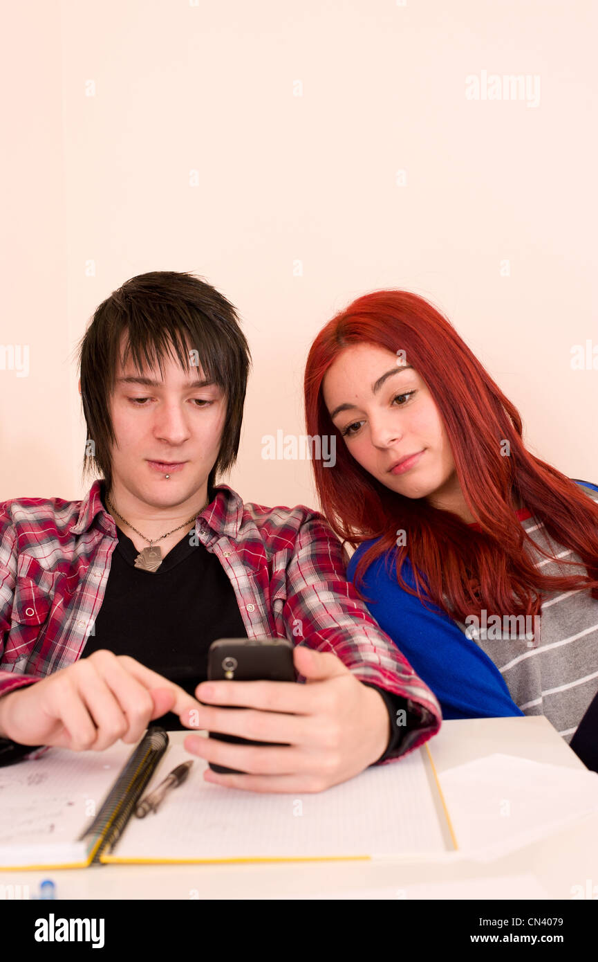 Students using a smartphone while studying Stock Photo - Alamy