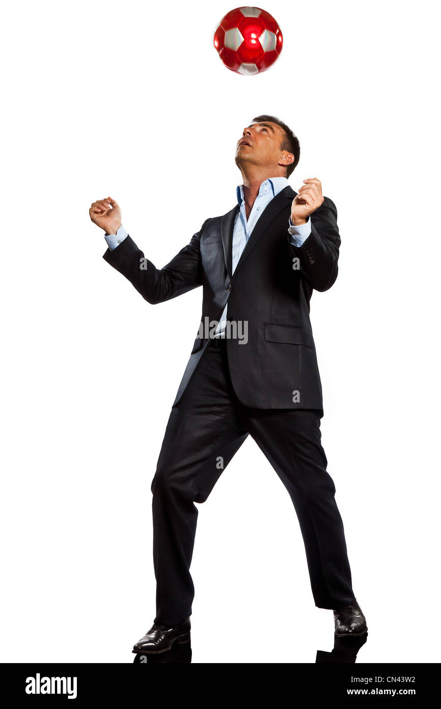 one caucasian business man playing juggling soccer ball in studio ...