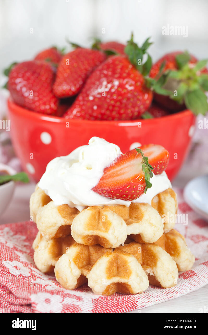 Delicious waffle with whipped cream and strawberries Stock Photo - Alamy