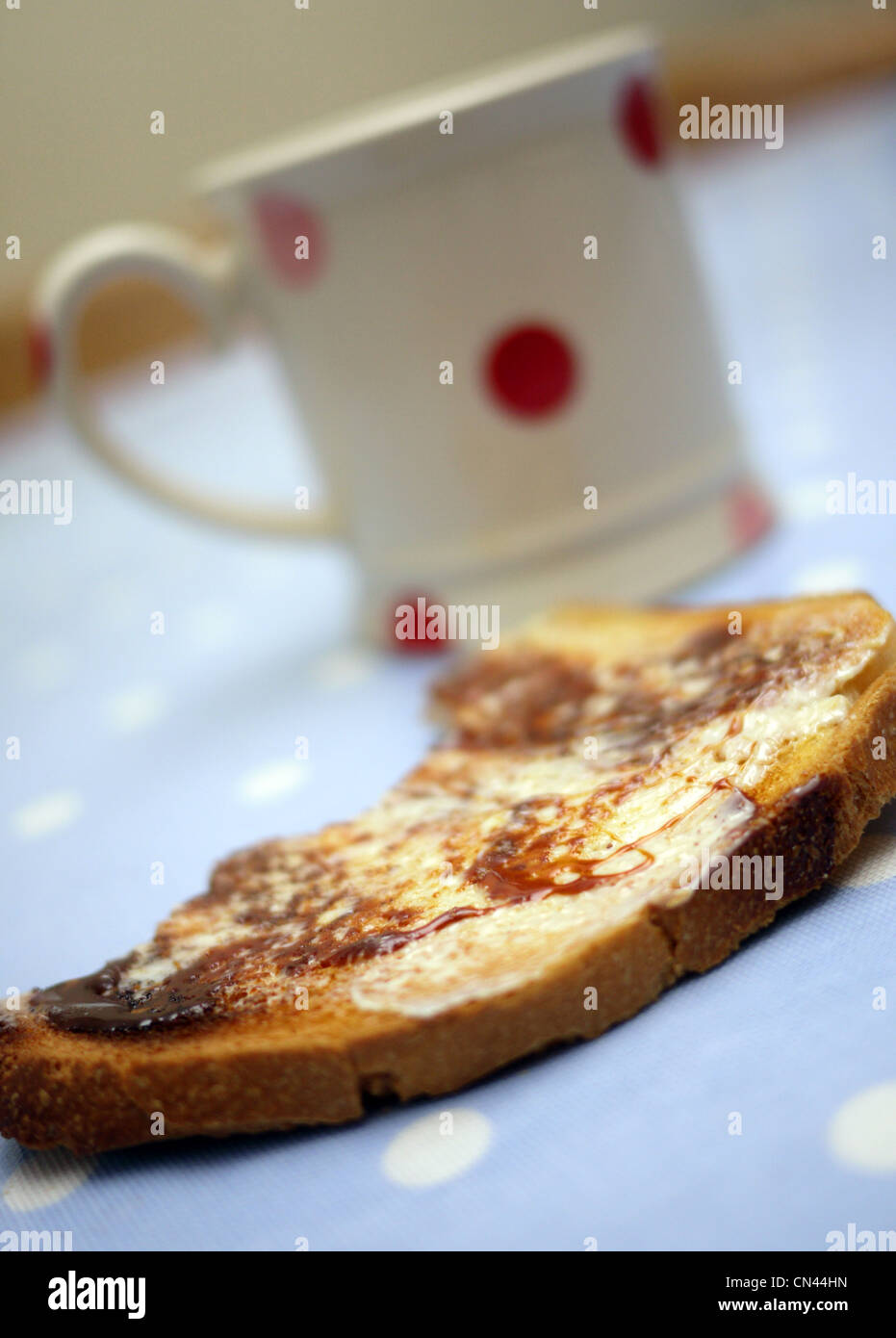 piece of toast and a coffee mug on a table Stock Photo - Alamy