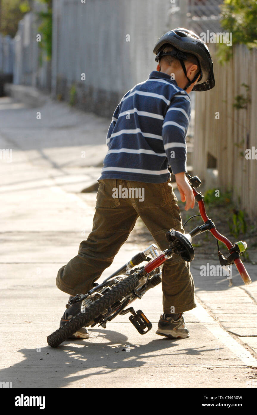 Boy Getting off Bicycle, Toronto, Ontario Stock Photo - Alamy