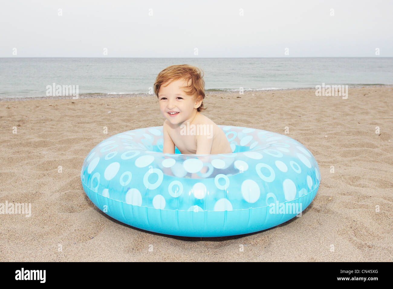 Young Boy Playing with Inner Tubes on a Beach, Toronto, Ontario Stock ...