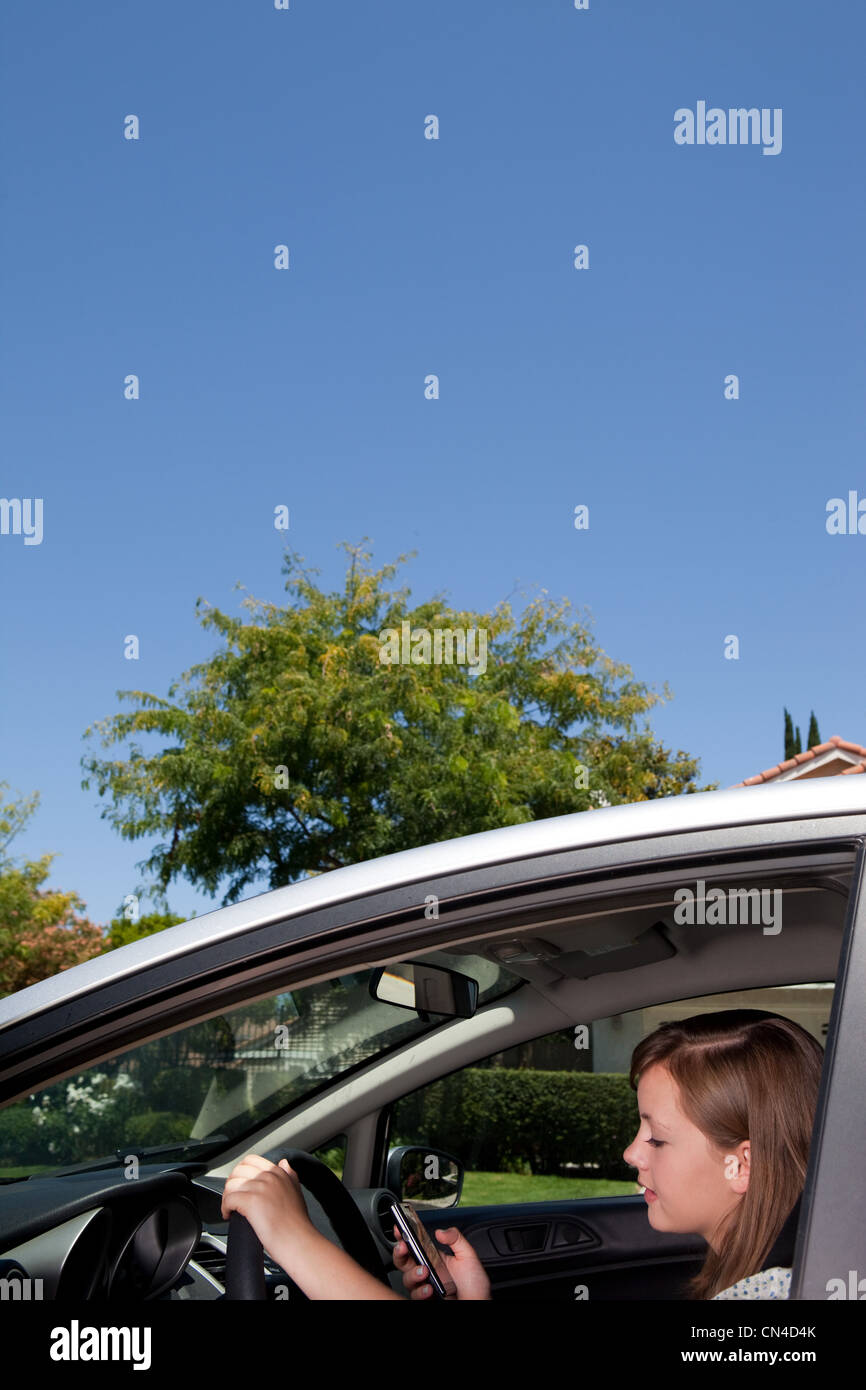 Teenage girl texting in car Stock Photo - Alamy