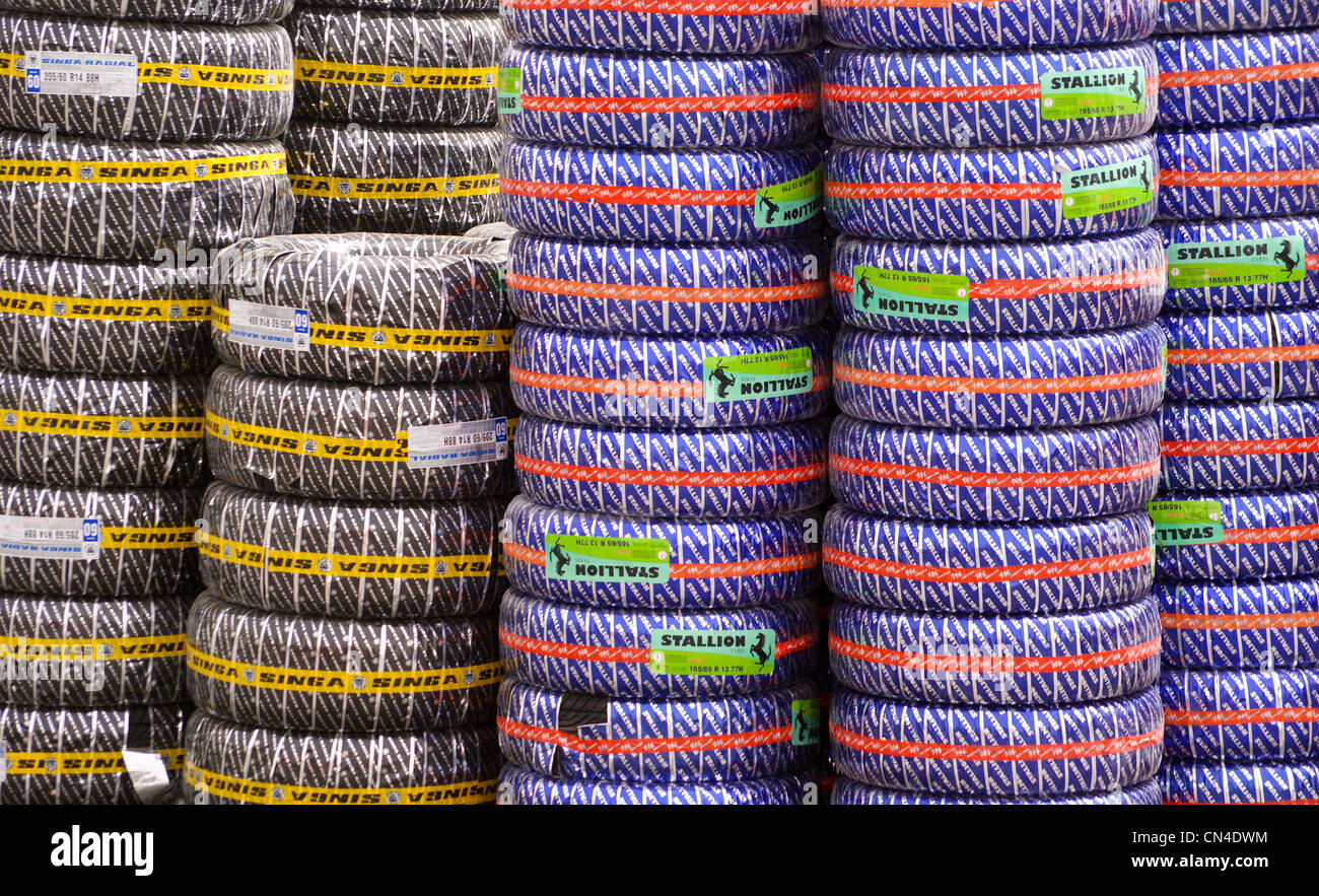 New car tyres wrapped in colourful packaging waiting to be loaded onto ...