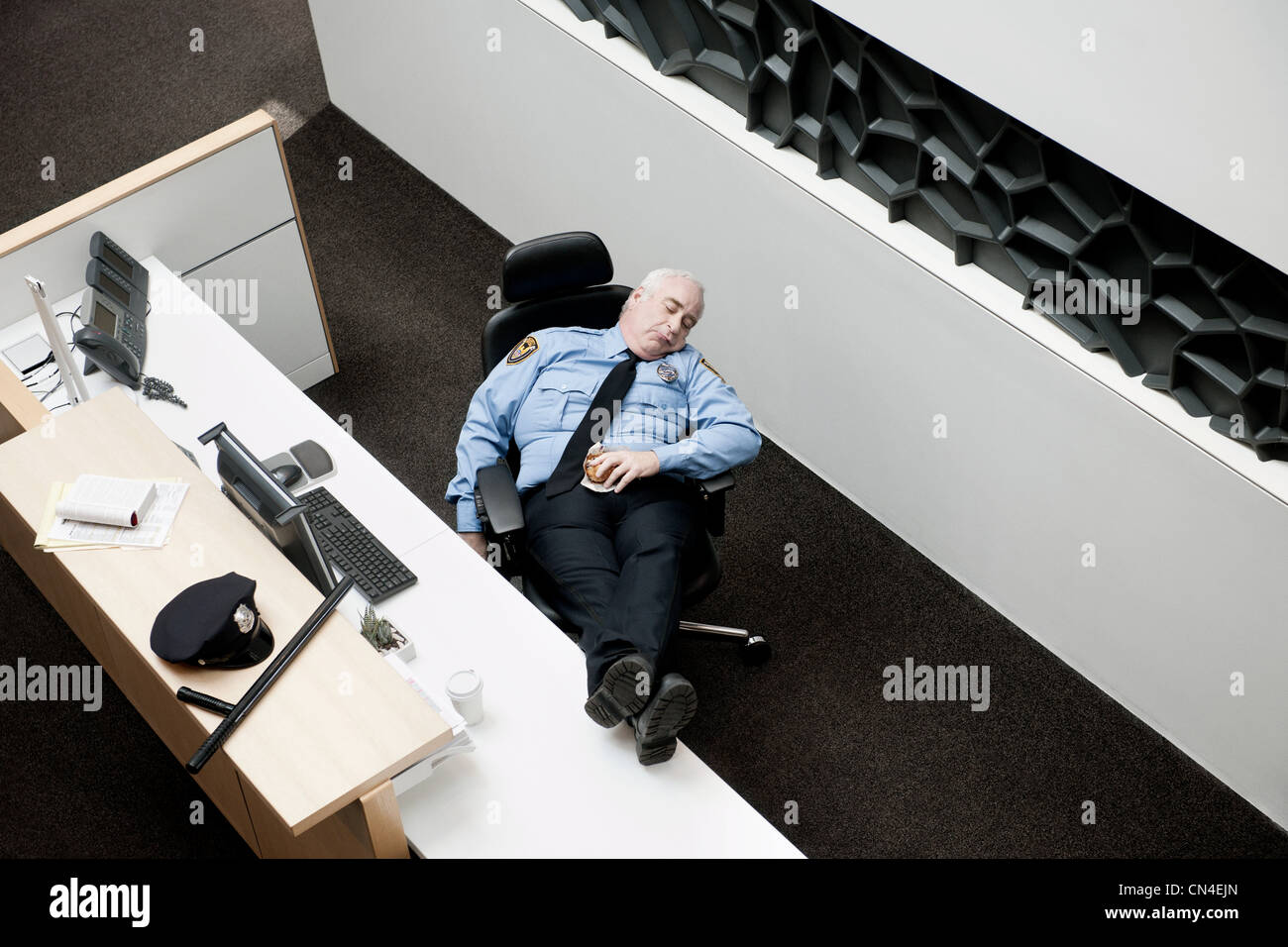 Security guard sleeping at desk Stock Photo - Alamy