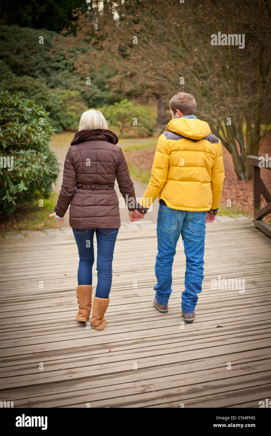 Couple Walking Hand in Hand on a Wooden Boardwalk in the Park Stock ...