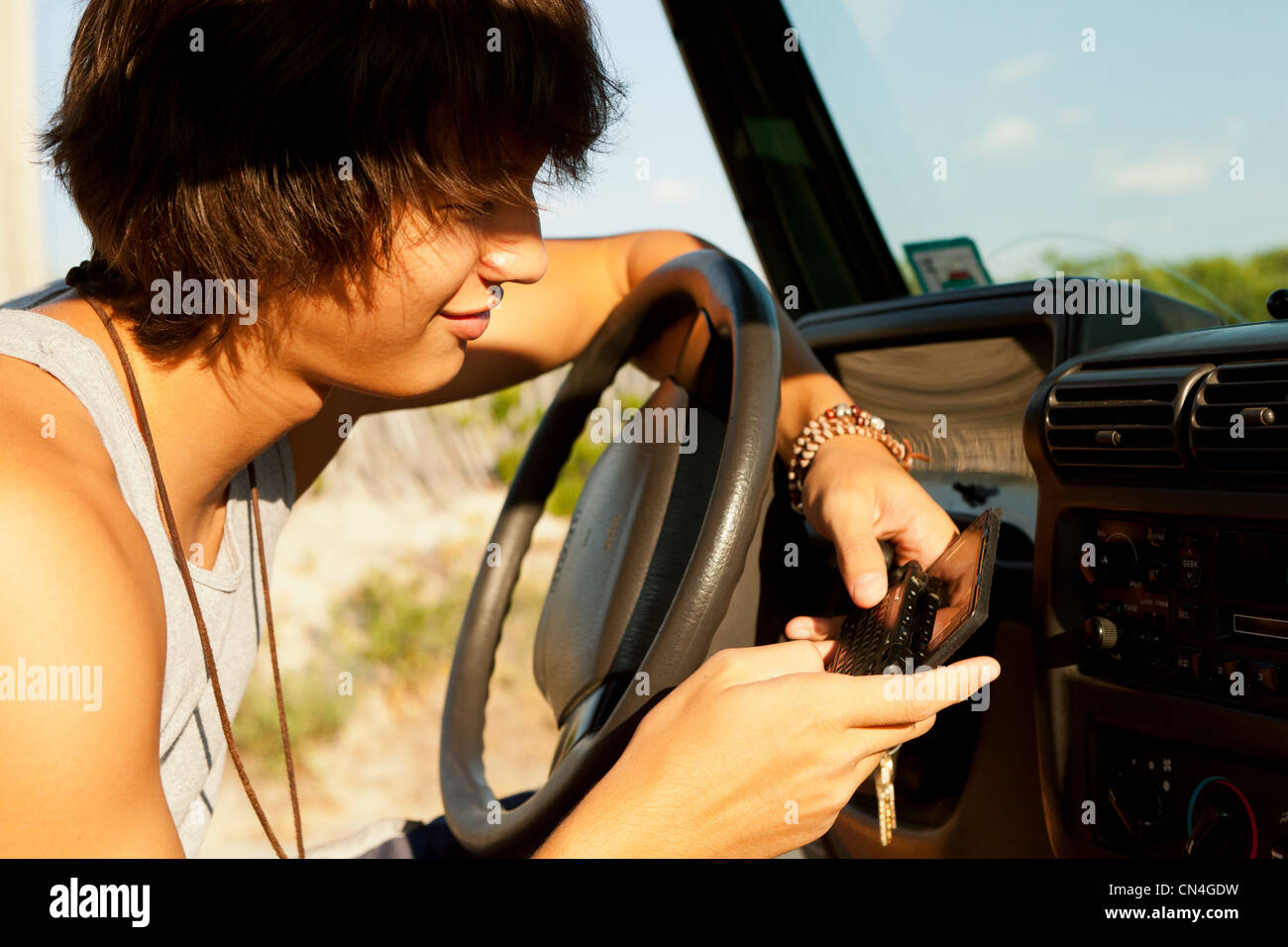 Teenager texting in his car Stock Photo - Alamy