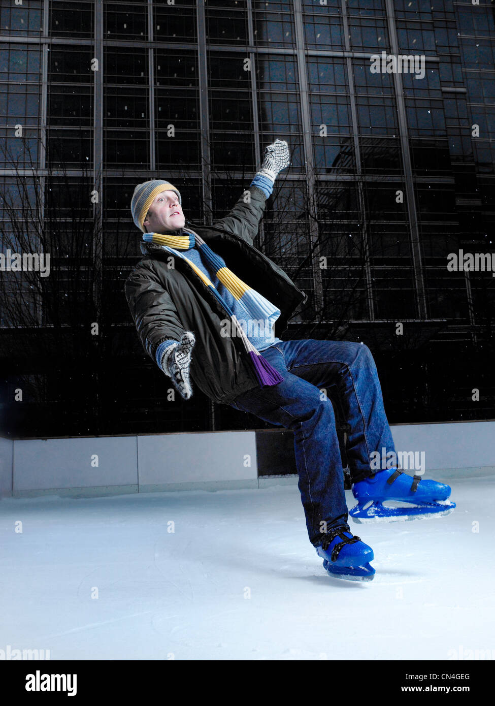 Man falling over on ice rink Stock Photo - Alamy