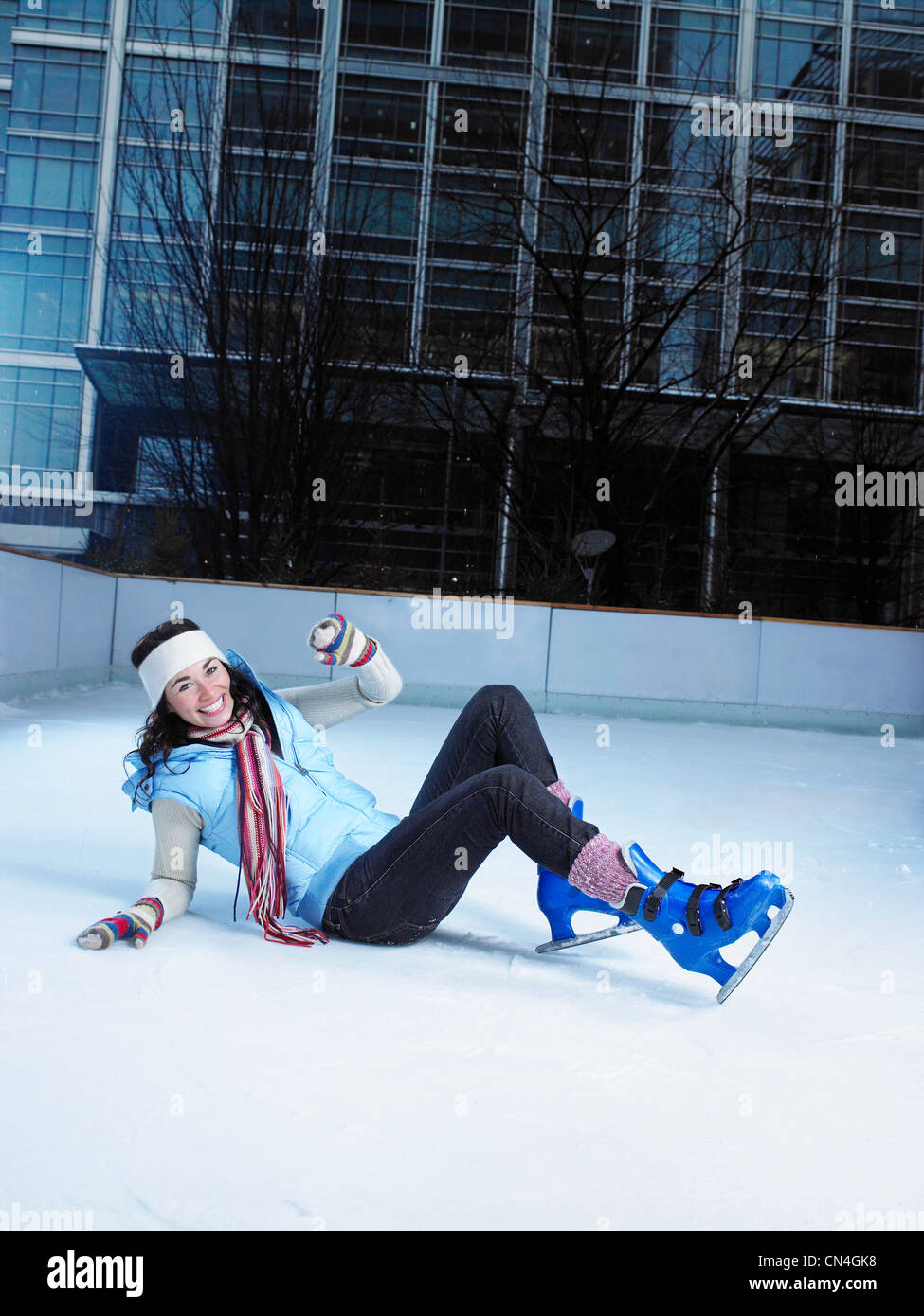 Woman lying on ice rink after falling over Stock Photo - Alamy