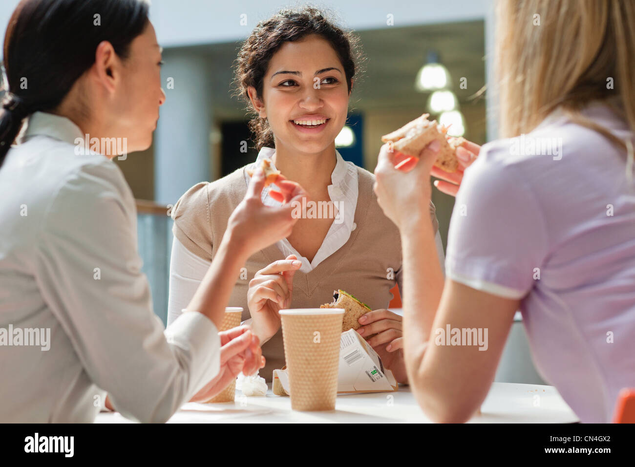 Office workers enjoying meal in office cafe Stock Photo - Alamy