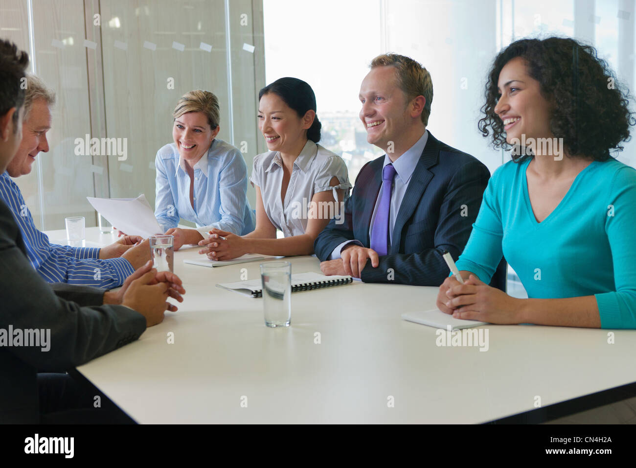 Office workers smiling in meeting in office Stock Photo - Alamy