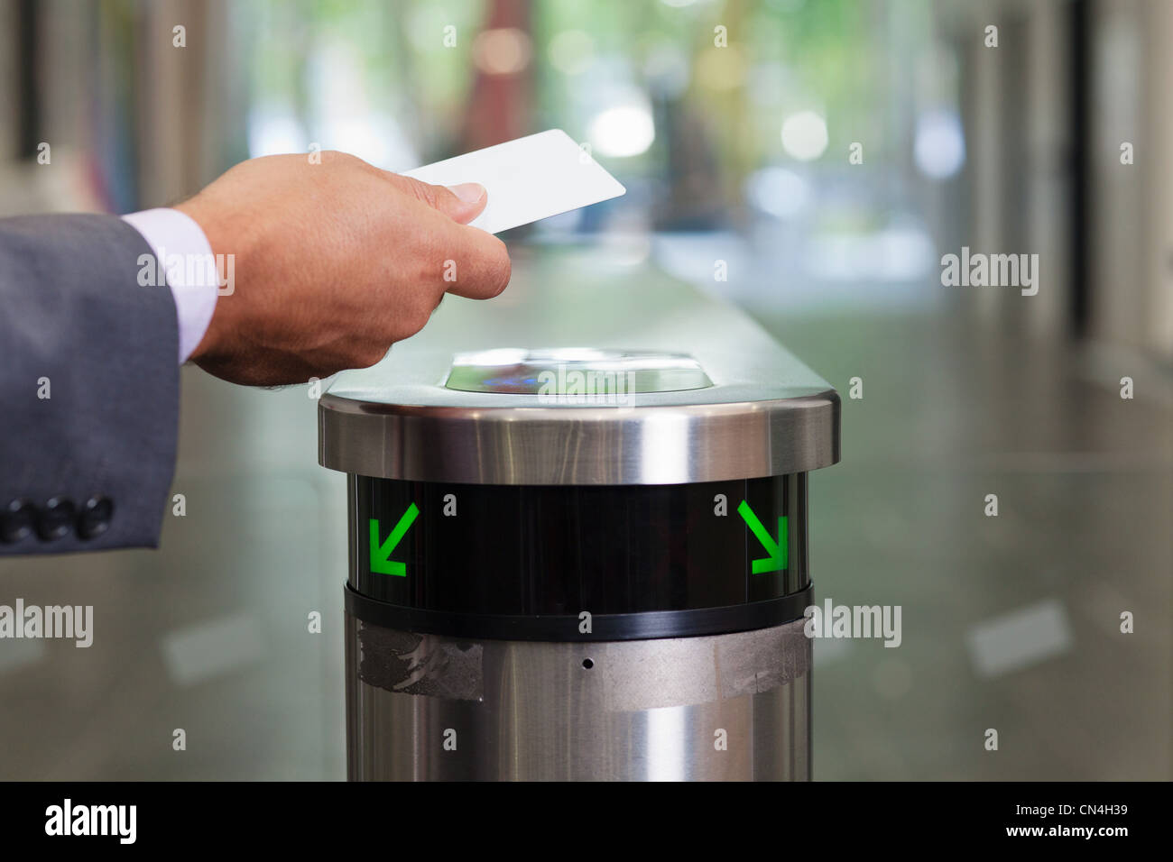 Mid adult businessmen swiping card through security gate Stock Photo ...