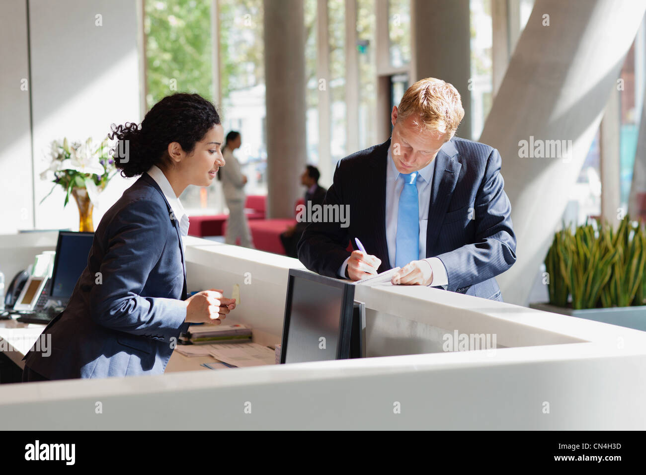 Asian male reception desk hi-res stock photography and images - Alamy