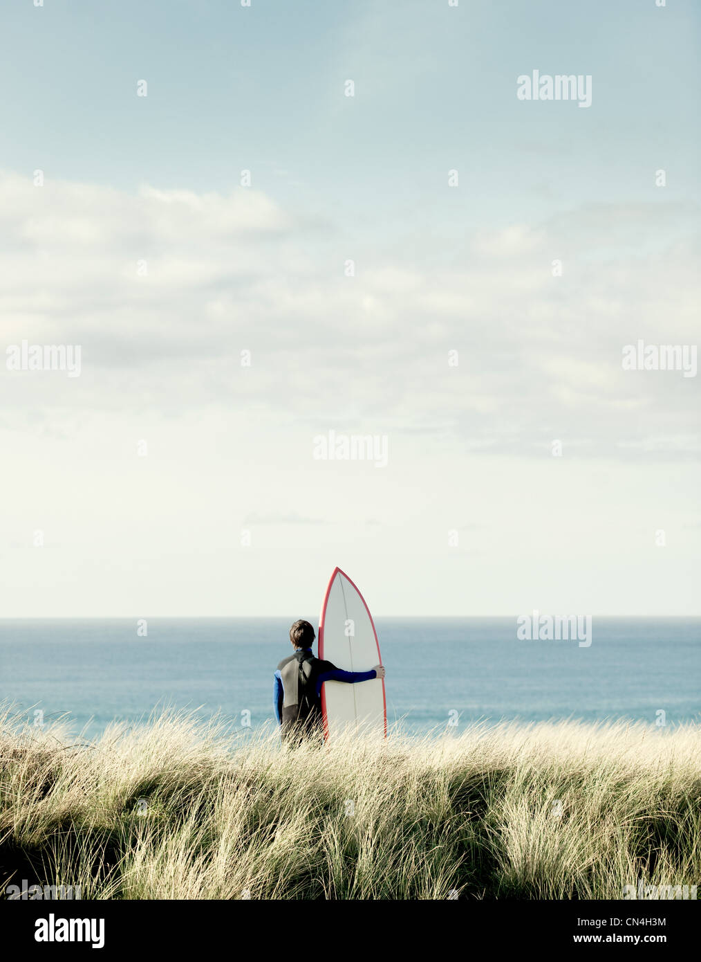 Surfer looking out to sea Stock Photo - Alamy