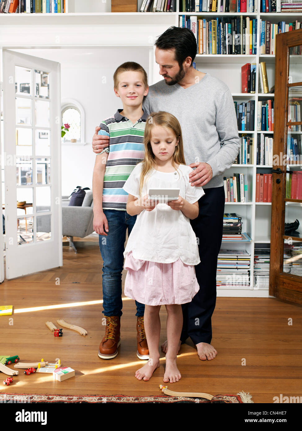Father and family standing together in living room, portrait Stock ...