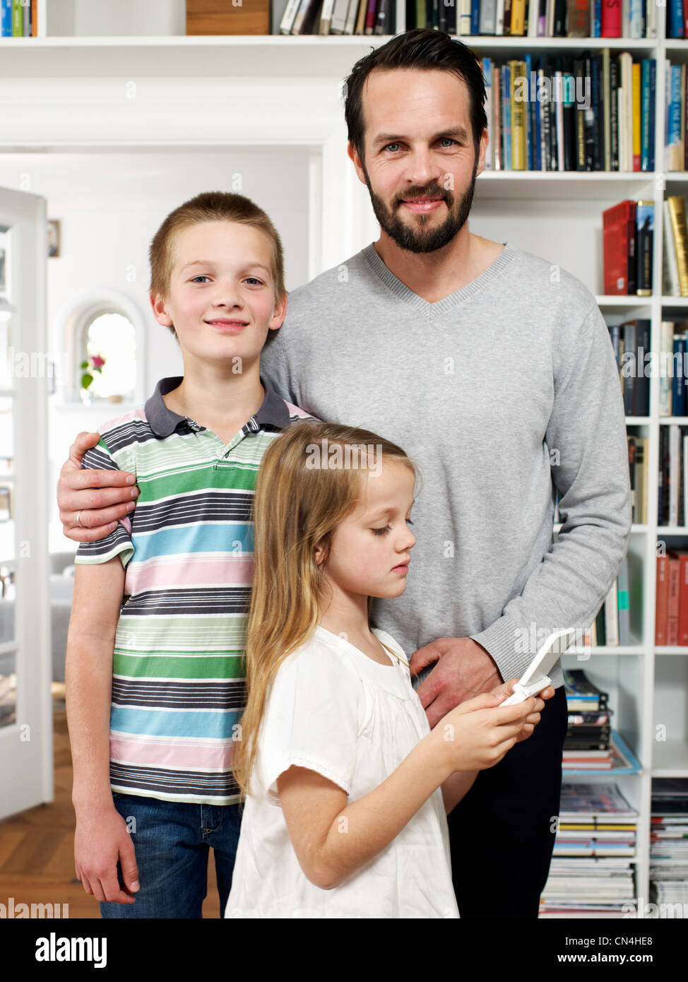 Father and family standing together in living room, portrait Stock ...