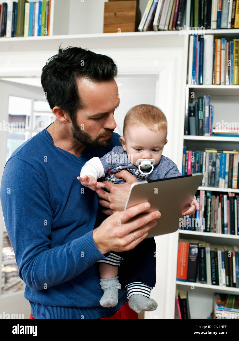 Father showing baby digital tablet Stock Photo - Alamy