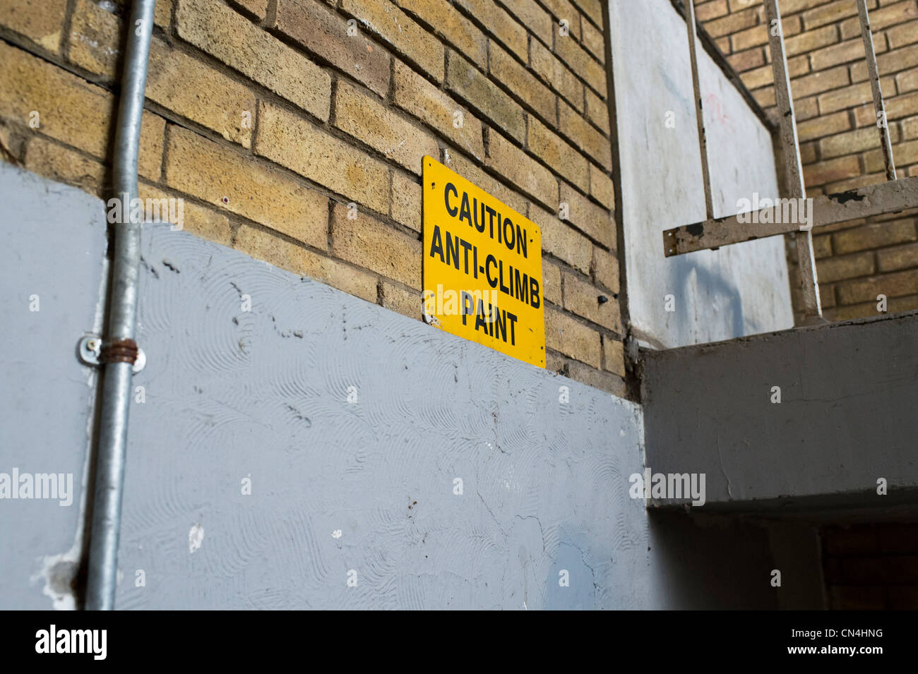 Warning sign of 'anti-climb paint' on stairwell in a block of social ...