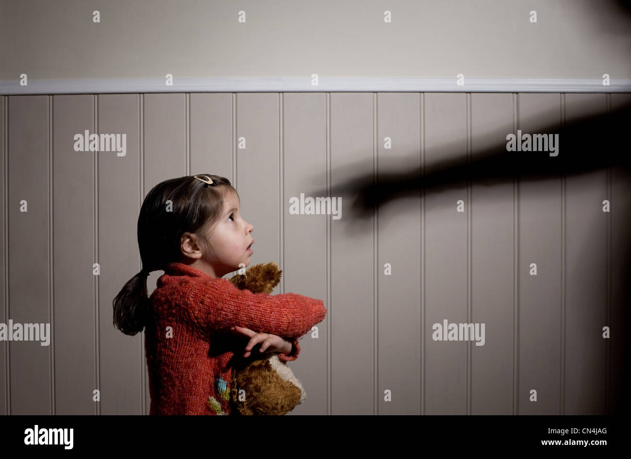 Frightened little girl and shadow of adult hand pointing at her Stock ...
