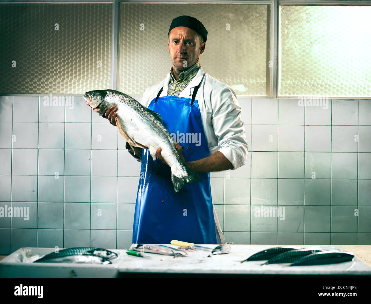 Fishmonger holding a salmon Stock Photo - Alamy