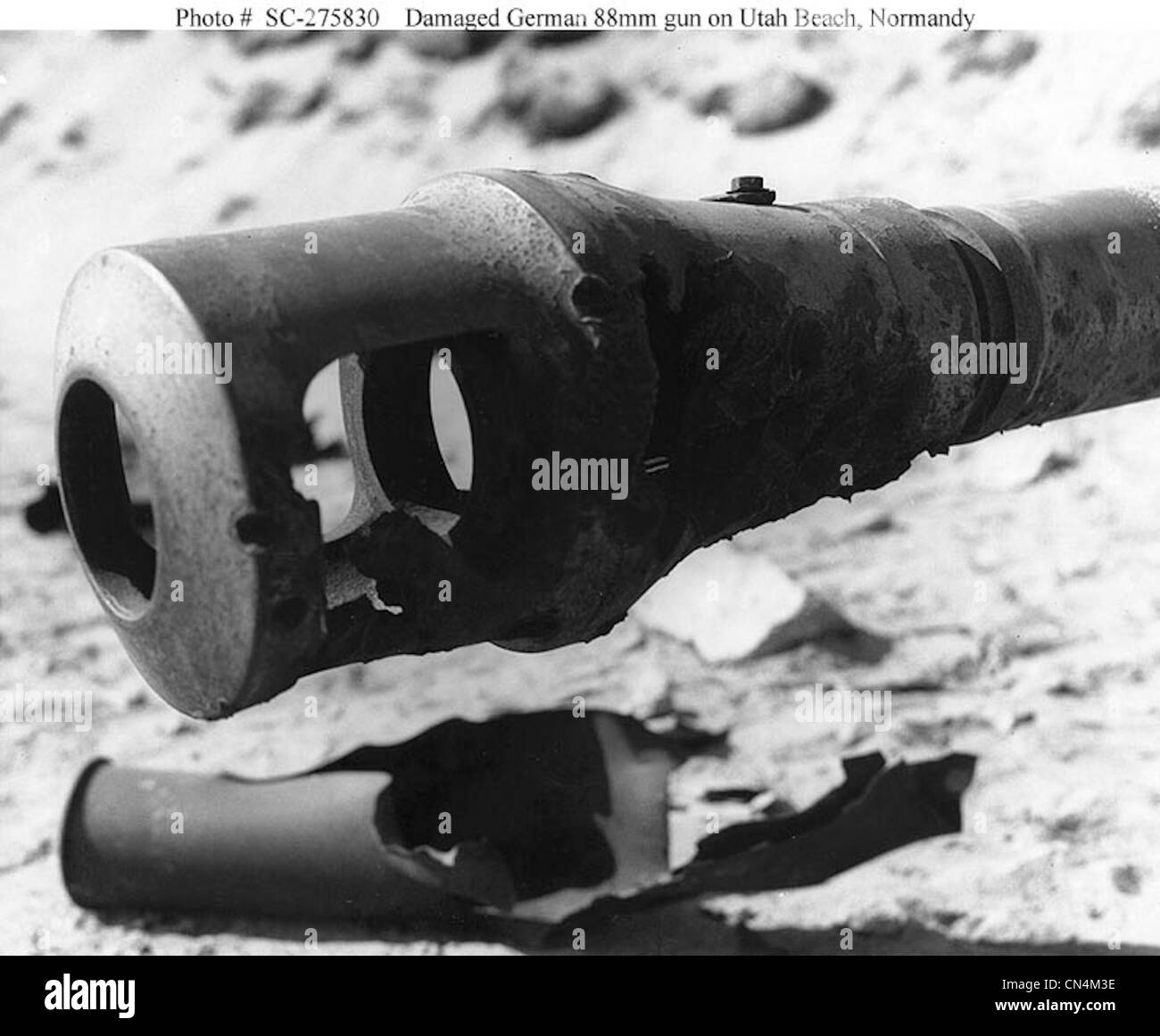 A damaged muzzle brake of a German 88mm gun, located in one of "Utah ...