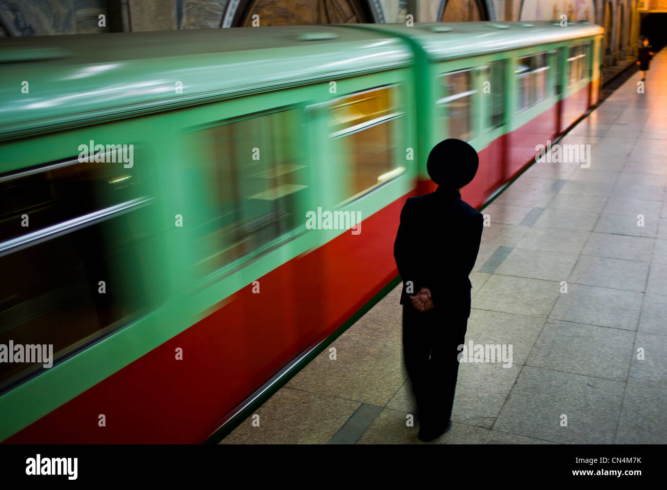 North Korea, Pyongyang, Puhung station, Pyongyang Metro staff watching ...