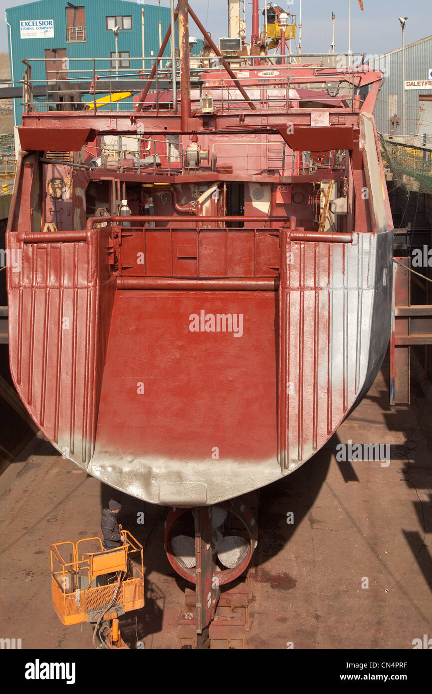 Fishing trawler in shipyard drydock facilities for repairs, maintenance ...