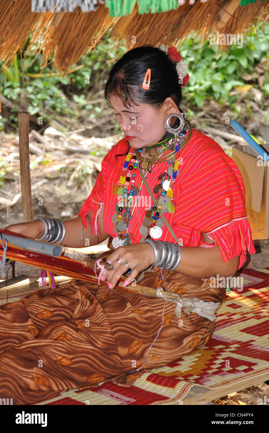 A Kayan Lahwi woman weaving at Karen Long Neck hill tribe village ...